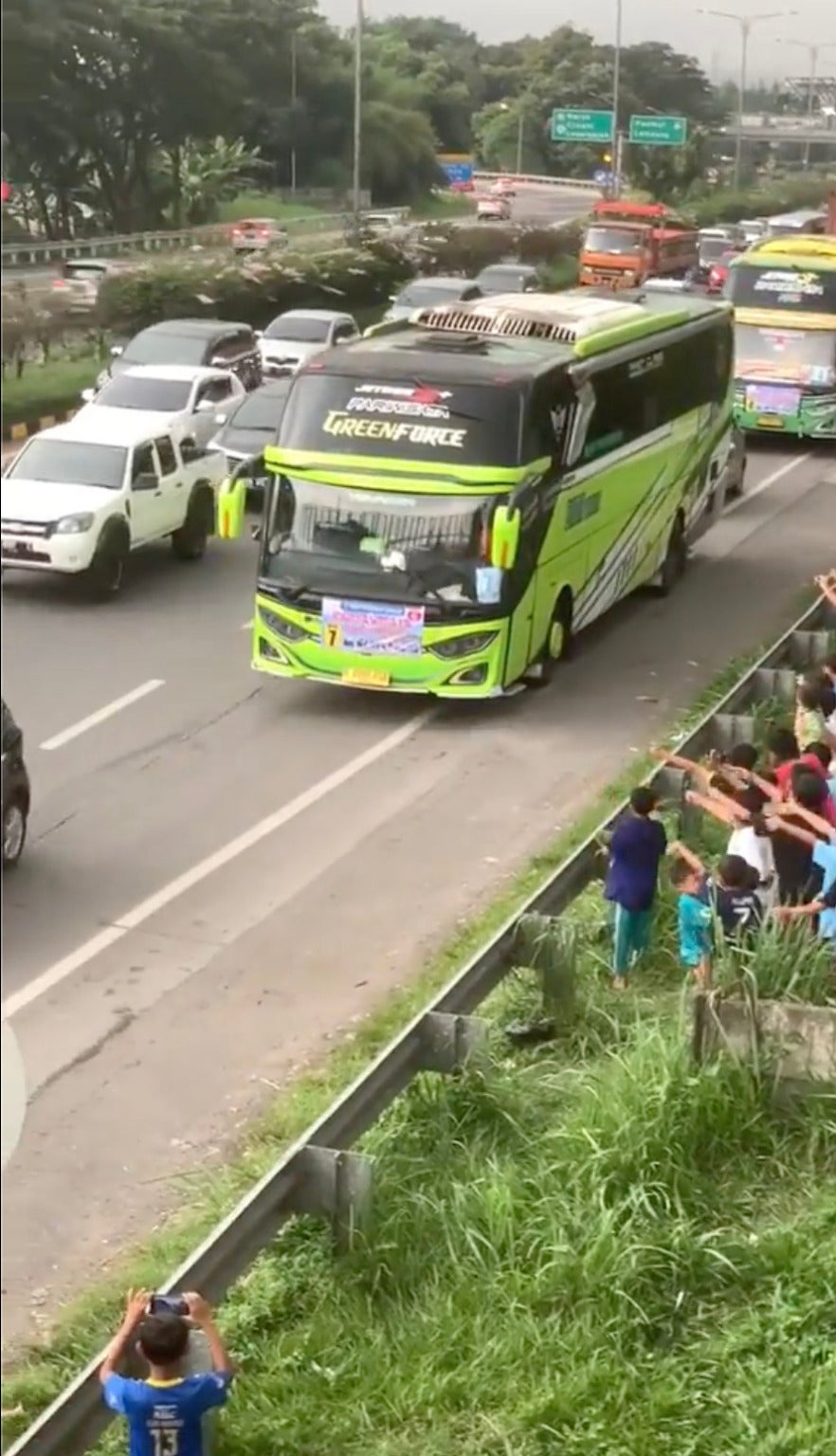 Indonesian Kids Waiting by Roadside Dance in Joy After Hearing Bus' Catchy Rhythmic Horns ...
